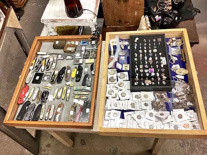 Pocket knives and coins under glass &ndash; small treasures meticulously arranged, waiting for the collector who needs just that one missing piece.
