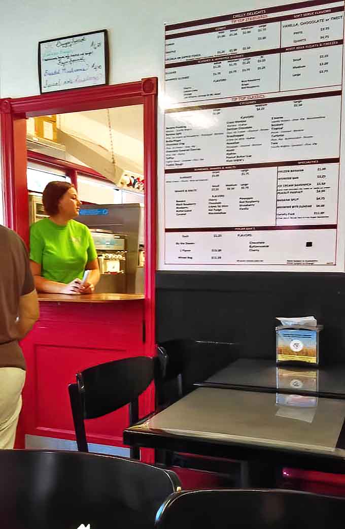 Behind the counter, staff work with the efficiency that comes from decades of perfecting the art of ice cream service.