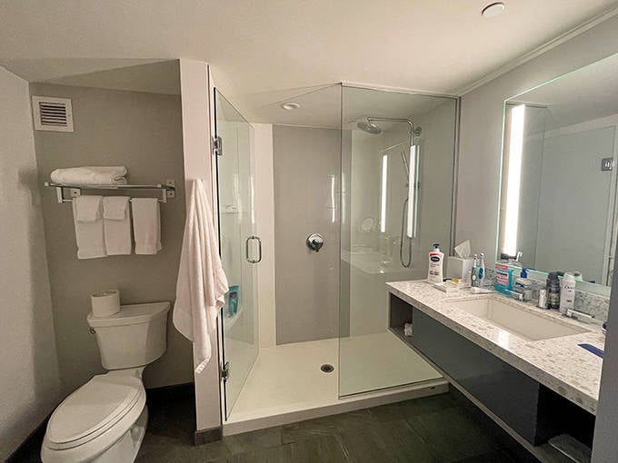 Bathroom spaces combine functionality with luxury, offering rainfall showers that ironically help you dry off after a day of getting wet.