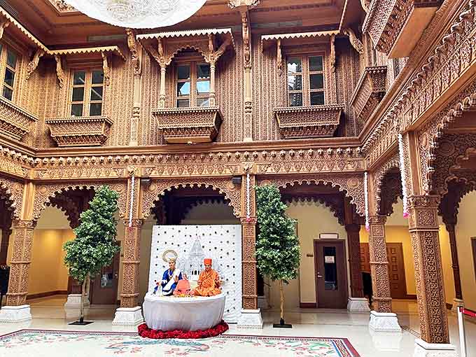 The wooden Haveli showcases a completely different architectural style, with warm tones and ornate carvings creating an intimate, welcoming atmosphere.