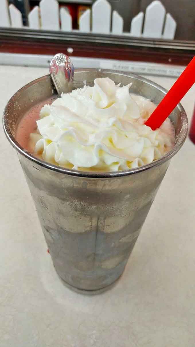 This isn't just a strawberry malt – it's a frothy time machine in a metal cup that transports you straight back to simpler days.