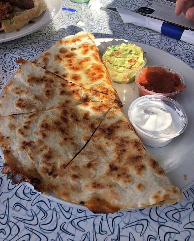 That quesadilla comes loaded with fillings and arrives with all the proper accompaniments for maximum enjoyment.