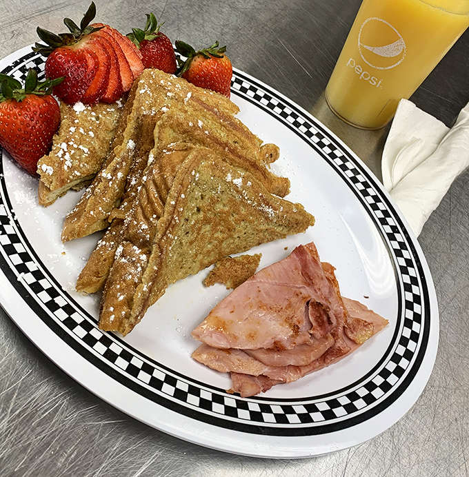 French toast dusted with powdered sugar alongside ham &ndash; simple breakfast perfection that doesn't need bells and whistles to impress.