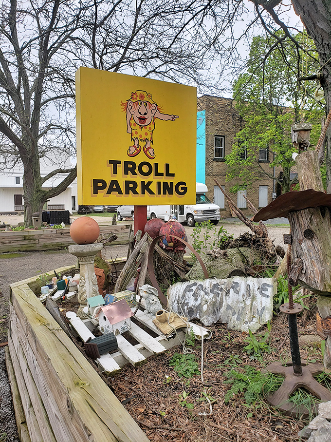 Even trolls need parking! This whimsical outdoor sign surrounded by garden oddities suggests the troll takeover extends well beyond the museum walls.