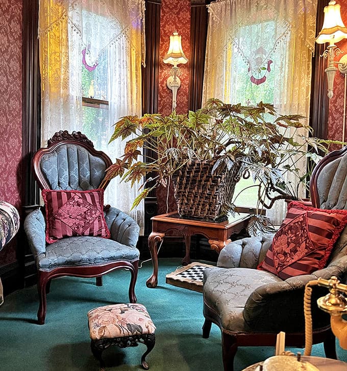 A quiet corner for conversation or contemplation, where antique chairs and delicate plants create a haven of Victorian tranquility.