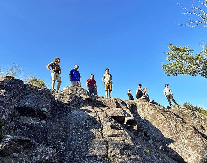 Explorers find their perfect perch atop ancient rocks, surveying a landscape that hasn't changed much since glaciers retreated thousands of years ago.