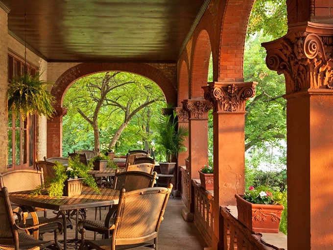 Arched columns frame nature's artwork, creating the perfect spot for morning coffee or evening contemplation on this magnificent veranda.