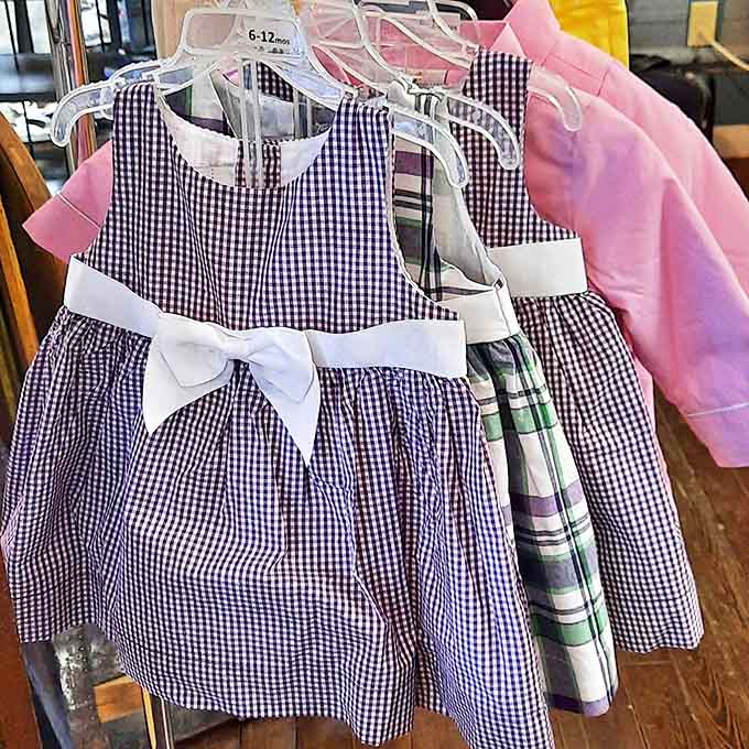 Tiny dresses with perfect bows wait patiently for their next special occasion, proving kids' clothes can have second acts too.