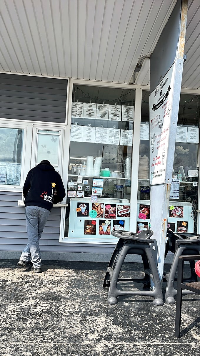 Where dreams come true and diets go to die – the friendly faces behind this window are the gatekeepers to flavor paradise.