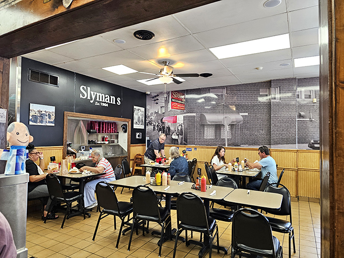 A typical lunchtime scene at Slyman's, where strangers become friends united by their mutual appreciation for monumental sandwiches.