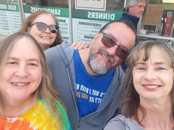 A group of happy customers sharing the Fast Eddie's experience – this is food that brings people together and creates lasting memories.