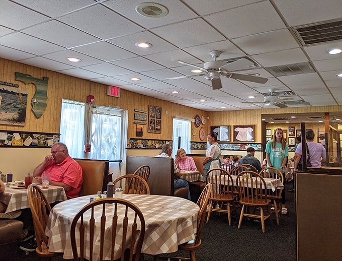 The dining room buzzes with conversation as multi-generational families gather around tables laden with comfort food classics and Amish specialties.