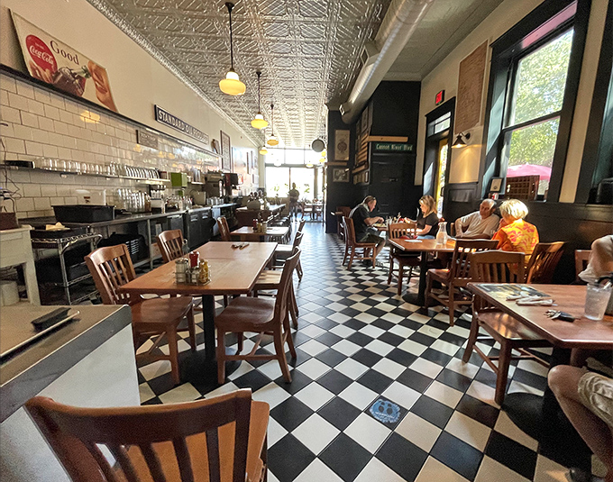 The dining area stretches long and narrow, with pendant lights casting a warm glow over conversations and coffee cups that never seem to empty.