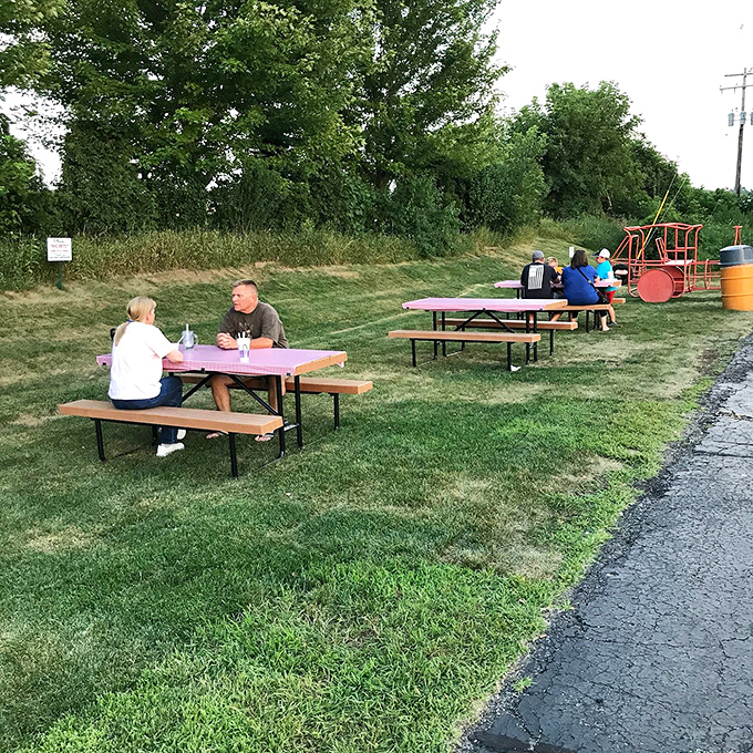 Picnic tables scattered across the grassy area invite families to linger over their meals while enjoying Wisconsin's precious summer evenings.