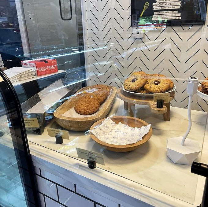 The display case: where diet plans go to die. Each wooden plate showcases cookies that look like they jumped straight out of a childhood dream.