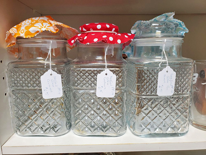 Grandma's kitchen preserved in time – vintage canisters with colorful fabric tops evoke mid-century domestic life in all its practical charm.