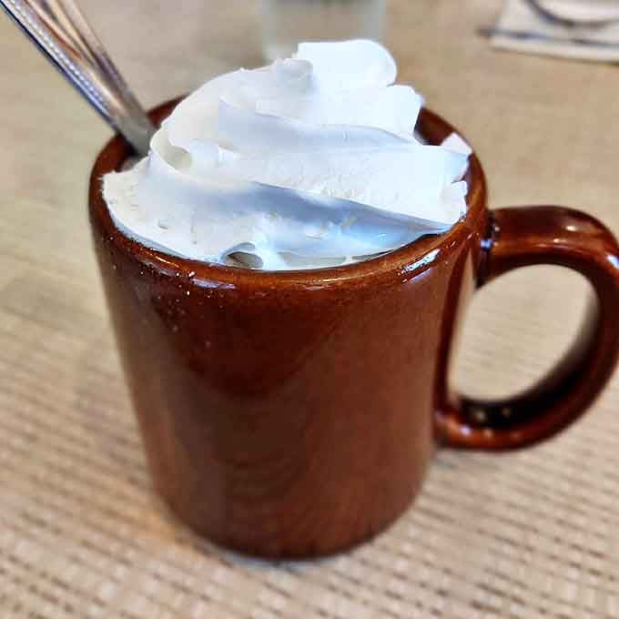 Hot chocolate topped with a cloud of whipped cream &ndash; the perfect companion for pancakes on a chilly Michigan morning.