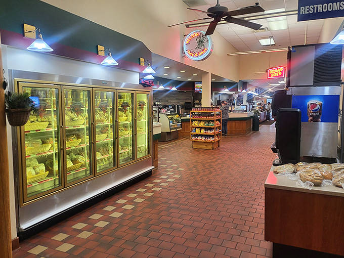 The interior walkway feels like wandering through a well-stocked cabin pantry, with refrigerated cases promising take-home treats for later.