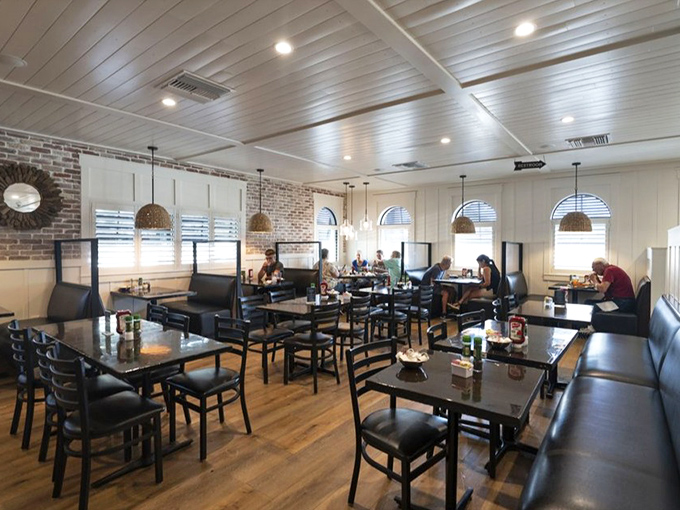 Modern coastal design with thoughtful touches &ndash; where brick walls, wooden tables, and strategic lighting create an atmosphere of casual elegance.