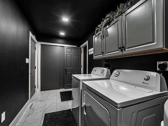 The laundry room proves that even the most mundane spaces deserve the dramatic treatment &ndash; sorting darks will never be the same.
