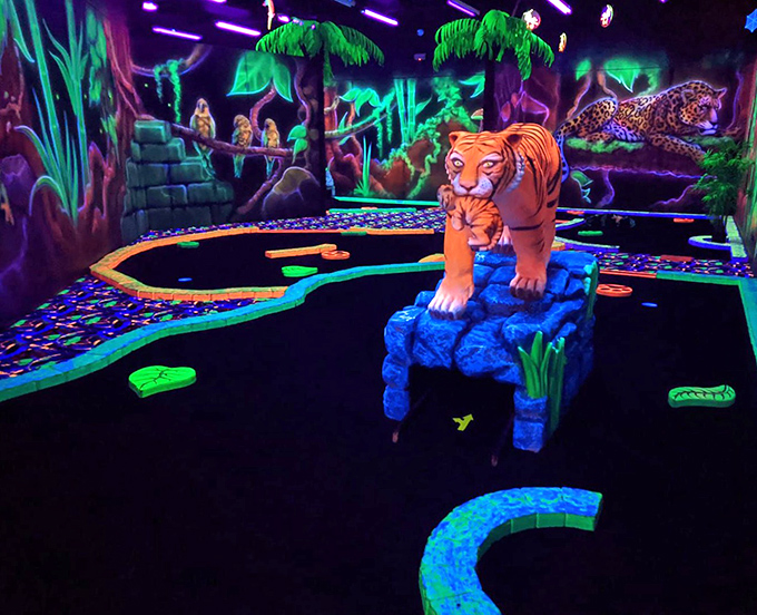 Tigers stand guard over challenging putting greens, their orange stripes practically pulsating against the electric blue course &ndash; mini-golf with attitude!