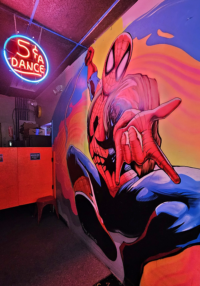 Even Spider-Man couldn't resist stopping by this arcade. The 5&cent; Dance sign hints at retro prices, though your quarters might need reinforcements these days.