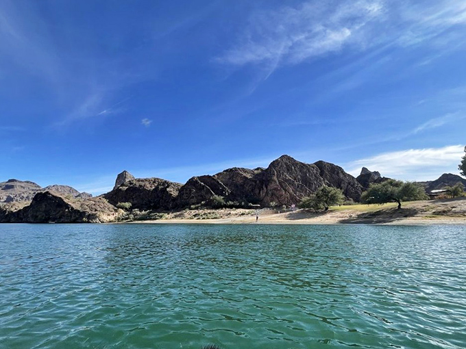 The distinctive mountain formations create a dramatic backdrop for water activities and shoreline relaxation.