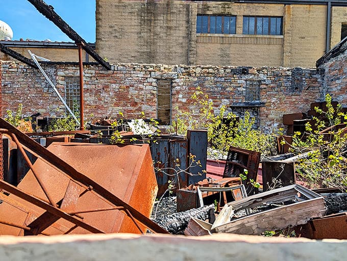 The prison's industrial yard, now a rusty graveyard of machinery and equipment, slowly surrenders to nature's persistent advance.