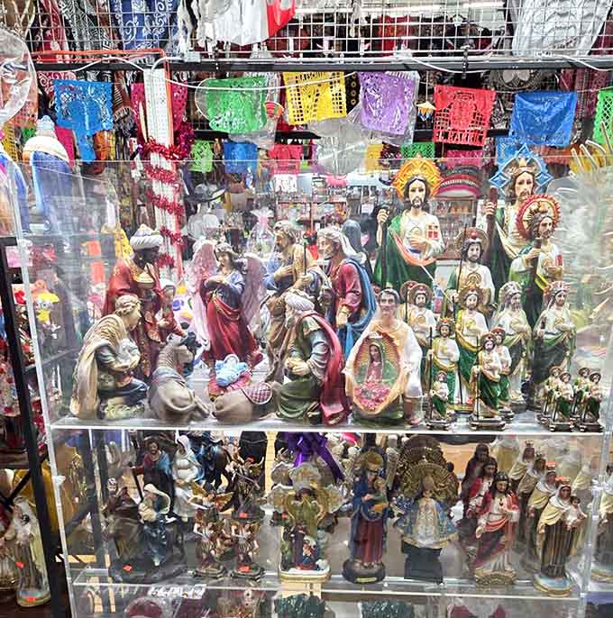 Religious figurines stand in silent dignity, offering spiritual comfort and artistic craftsmanship to those seeking something meaningful among the merchandise.