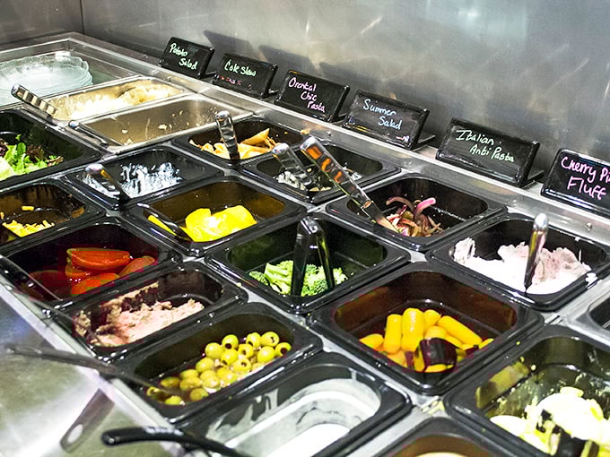 The salad bar offers fresh ingredients for creating your perfect plate – a rainbow of options for the health-conscious diner.