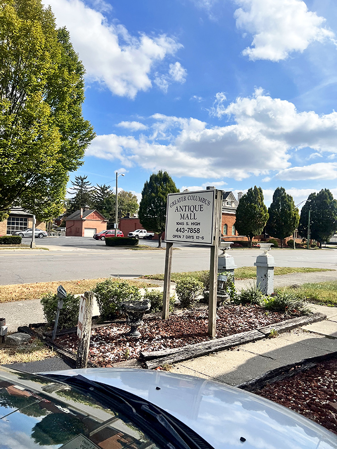 Sunlight catches the vintage sign that has guided collectors and curiosity-seekers to this treasure trove for years, promising "OVER 70 DEALERS" inside.