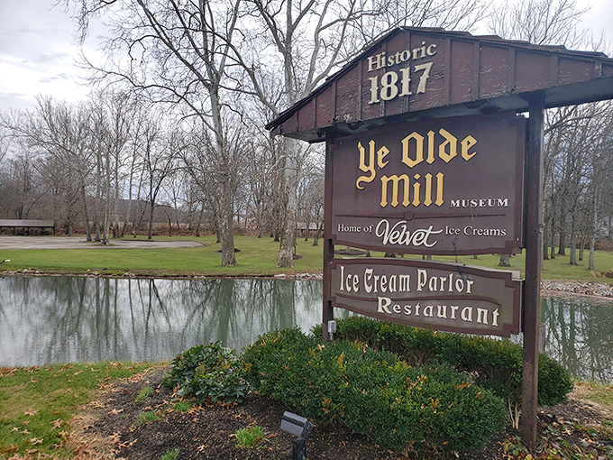 The weathered sign stands sentinel by the water, promising visitors they've found the ice cream equivalent of the promised land.