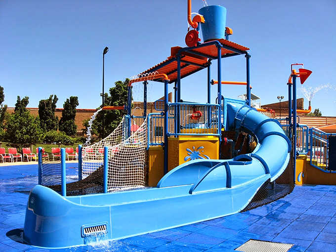 The slide's gentle curve promises a smooth ride before the inevitable splash, like a rollercoaster designed by mermaids.
