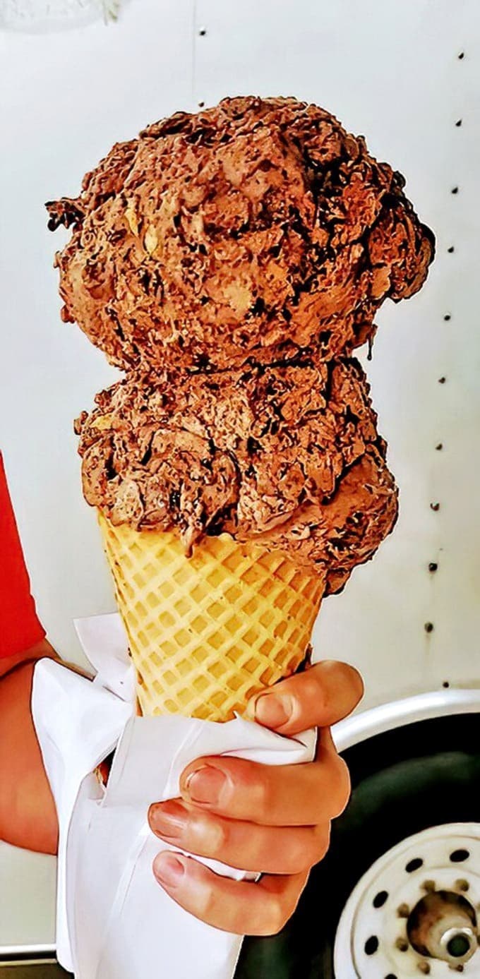 Two scoops of pure Michigan magic – one white, one pink, both extraordinary. This isn't just dessert; it's a vacation in edible form.