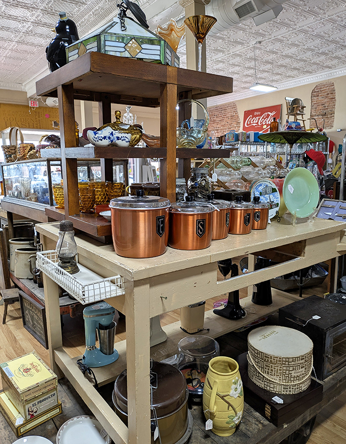 Vintage kitchen canisters and copper cookware gleam under the lights, their patina telling stories of countless meals prepared with love.