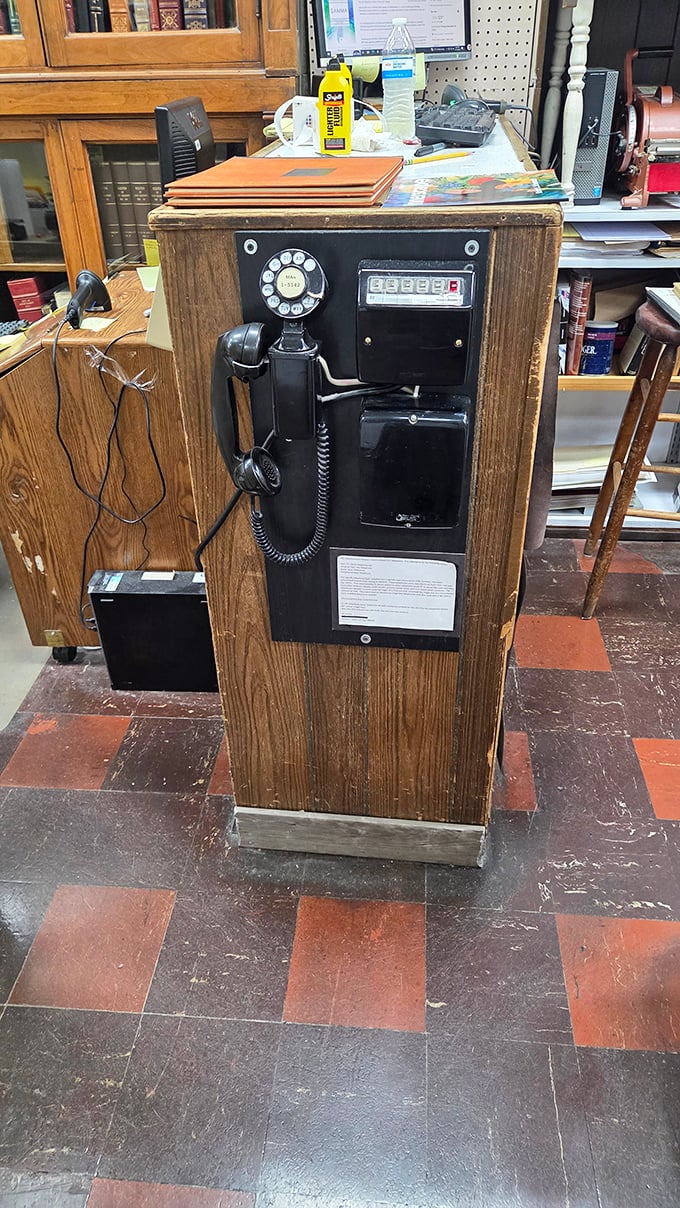 The vintage payphone stands as a charming anachronism, a reminder of communication before smartphones invaded our literary sanctuaries.