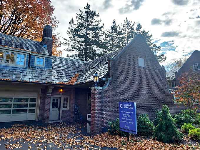 The visitor services building welcomes guests with warm brick and practical information &ndash; the gateway to your journey through Michigan's elegant past.