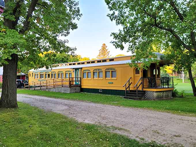 Stone pathways connect the various railcars, creating a miniature village feel that invites exploration and discovery.