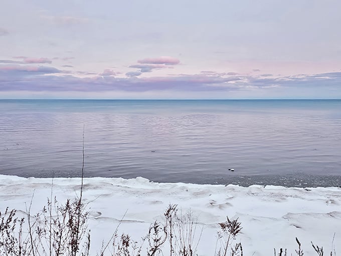 Winter transforms the beach into a monochromatic masterpiece, where ice sculptures form naturally along the shore's edge.