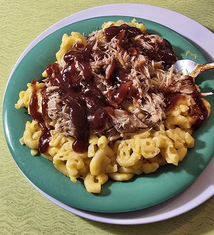 Mac and cheese topped with pulled pork and barbecue sauce &ndash; a glorious comfort food mashup that makes taste buds dance with delight.