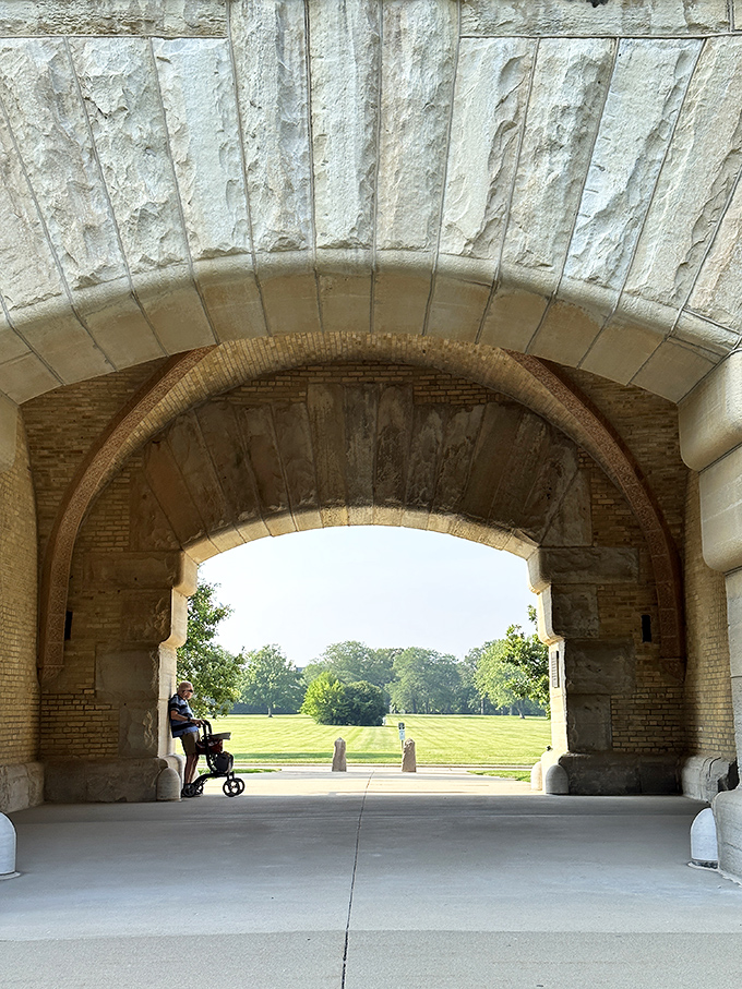 The magnificent stone archway frames a perfect view of the parade grounds, creating a portal between past and present.