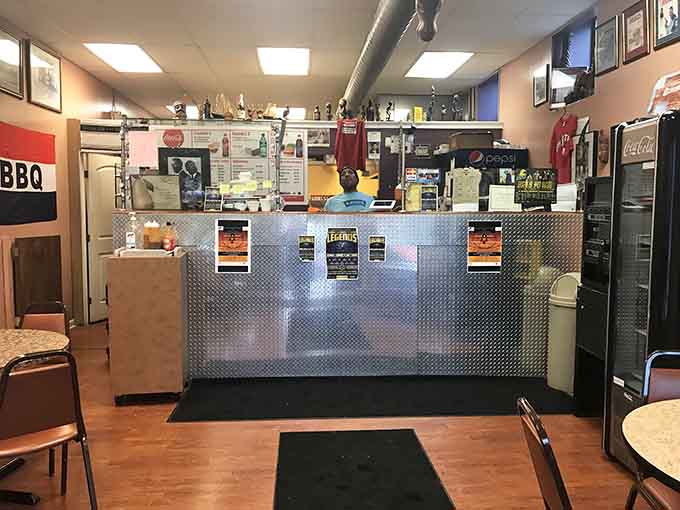 The stainless steel counter gleams with promise, standing between hungry customers and the smoky paradise that awaits just beyond those kitchen doors.