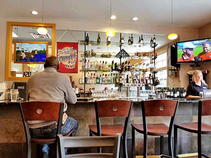 The well-stocked bar area provides a comfortable spot for solo diners or friends gathering for drinks and conversation in a warm, welcoming atmosphere.