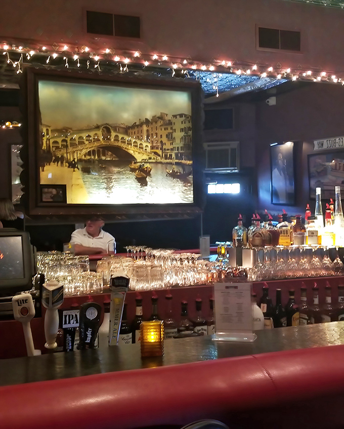 Bar: A painting of Venice's Rialto Bridge watches over the well-stocked bar, where skilled bartenders craft drinks that complement the kitchen's Italian masterpieces.