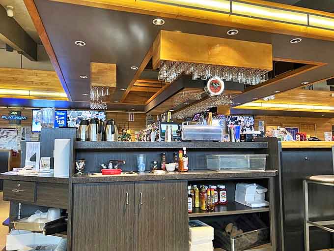 The bar area combines rustic charm with modern touches, creating a welcoming space where locals gather to watch games and travelers unwind after a day on the road.