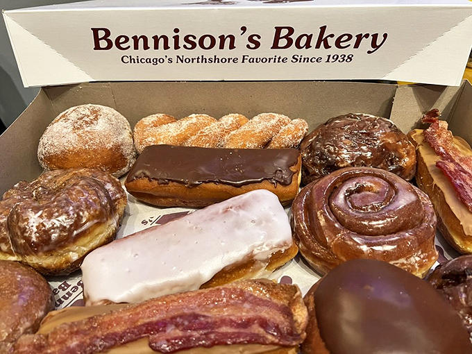 Assorted donuts arranged in perfect rows like a sugary rainbow, each one handmade and ready to make your morning infinitely better.