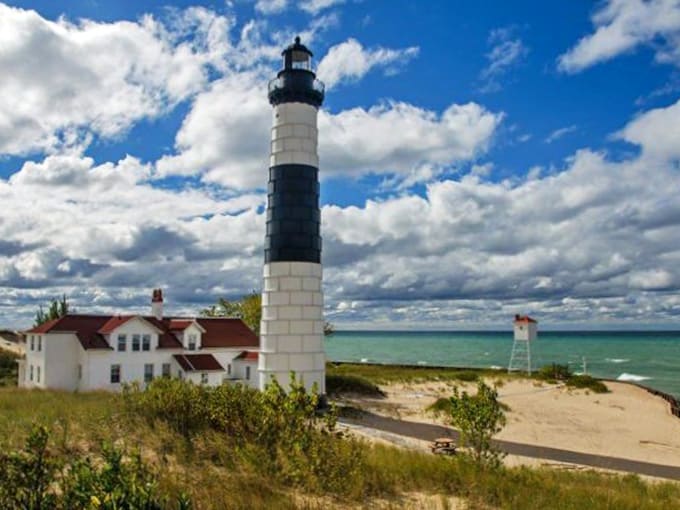 Big Sable Point Lighthouse stands tall against Michigan's temperamental skies, its distinctive black and white stripes a beacon for ships and photographers alike.