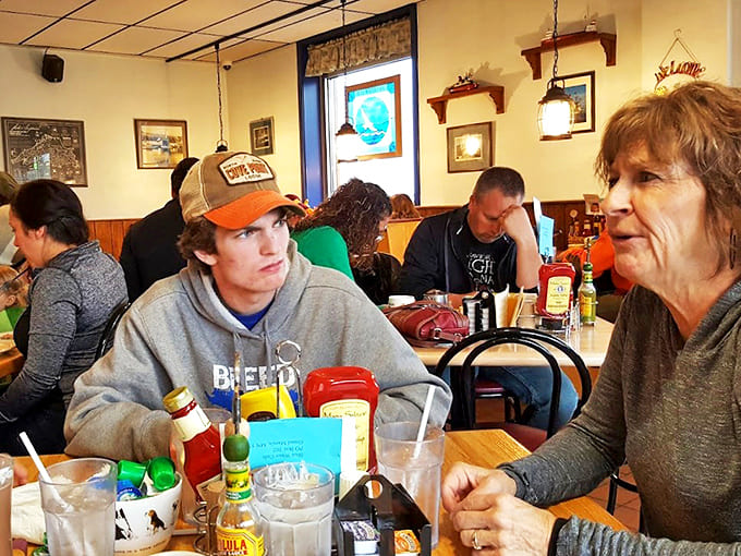 Happy diners gather around tables filled with sweet and savory creations, proving that good food is always better when shared.