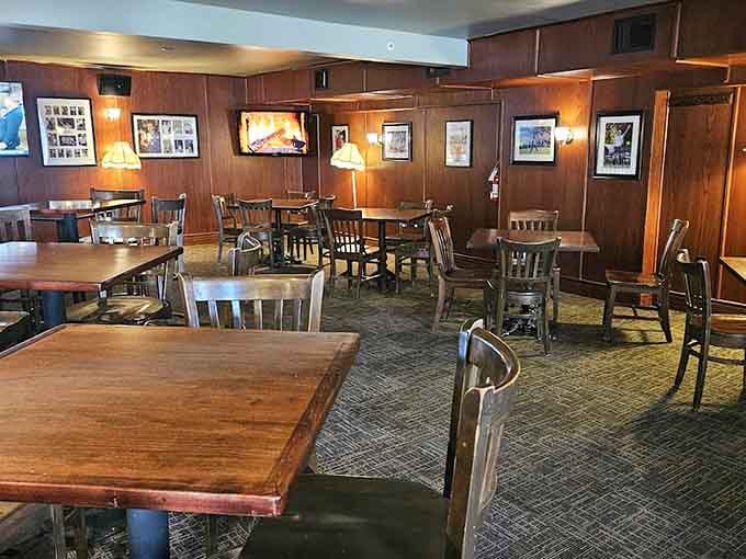Spacious dining room with wooden tables where friends gather, families celebrate, and strangers become regulars over great food and conversation.