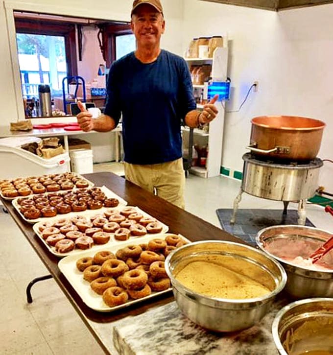 The maestro behind the magic stands proudly with his creations &ndash; each tray representing hours of craftsmanship and generations of donut-making wisdom.
